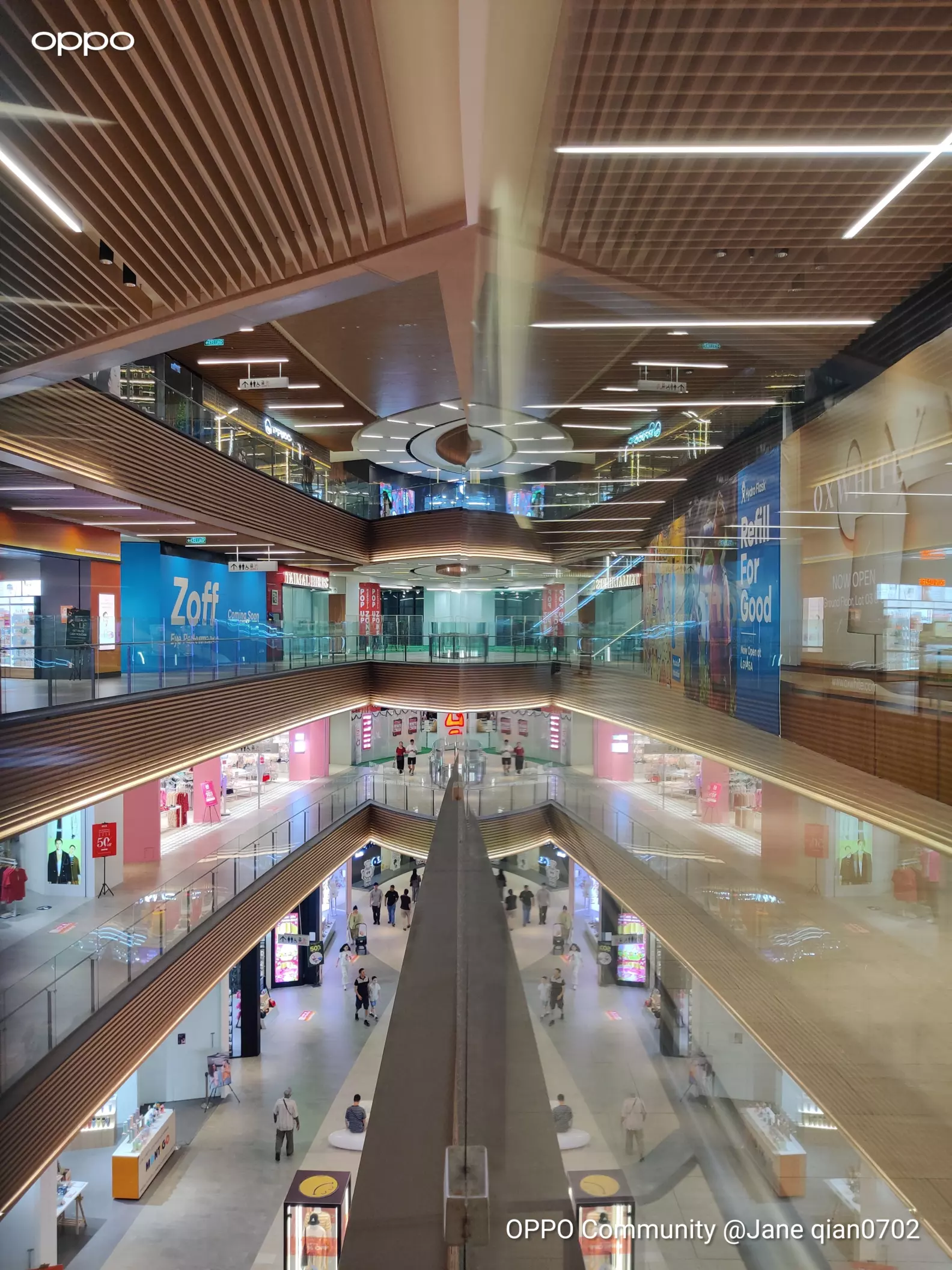 A modern shopping mall with sleek, symmetrical architecture,
