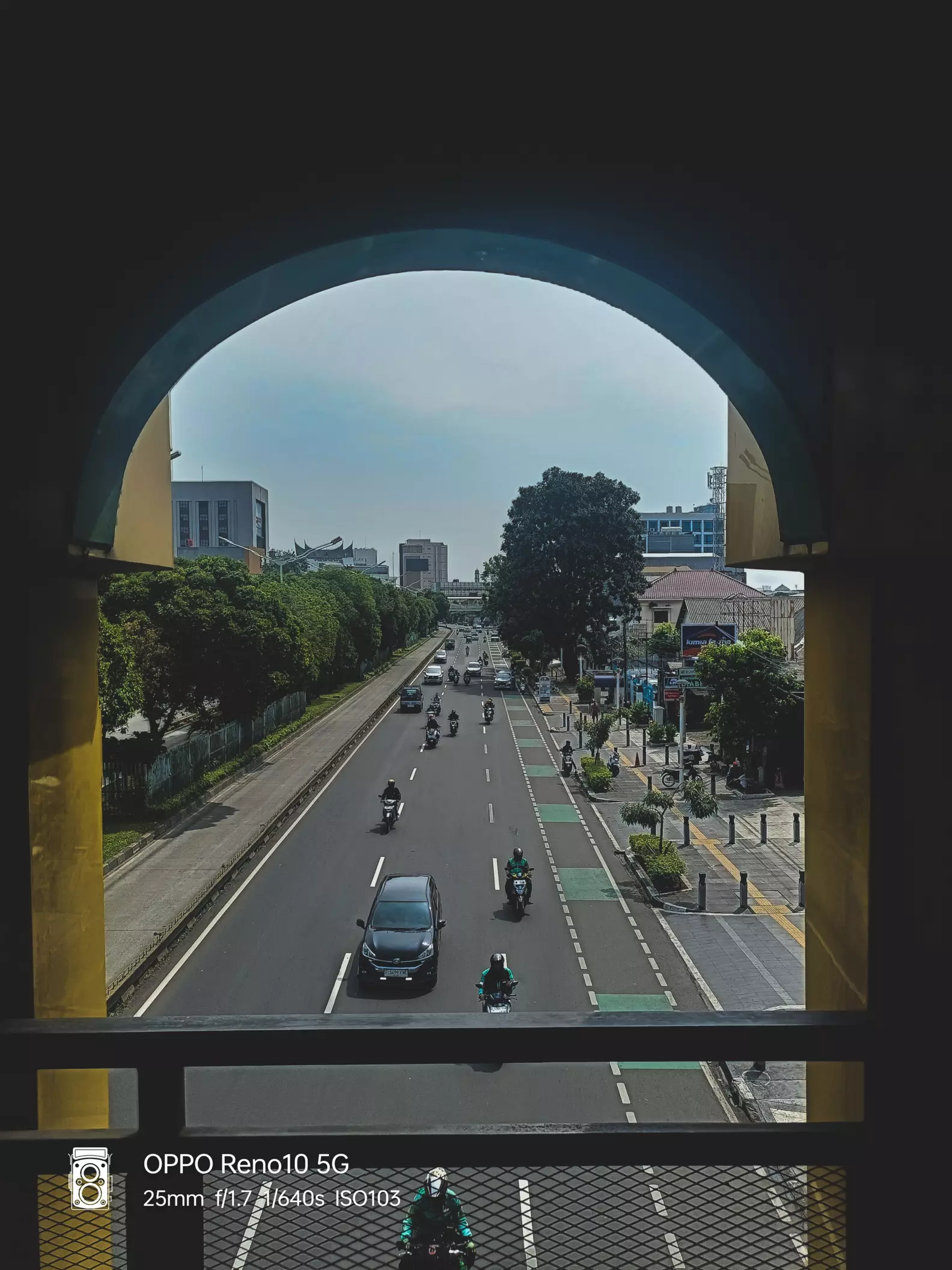 Framed by the arch of Matraman pedestrian bridge, Jakarta’s