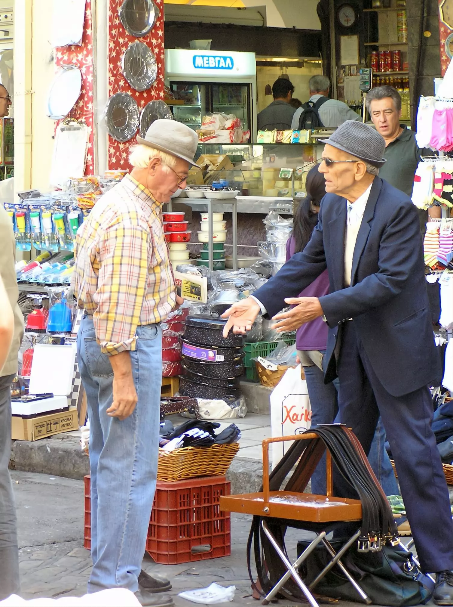 Two elderly men—Nikos, a market vendor, and Stavros, a retir