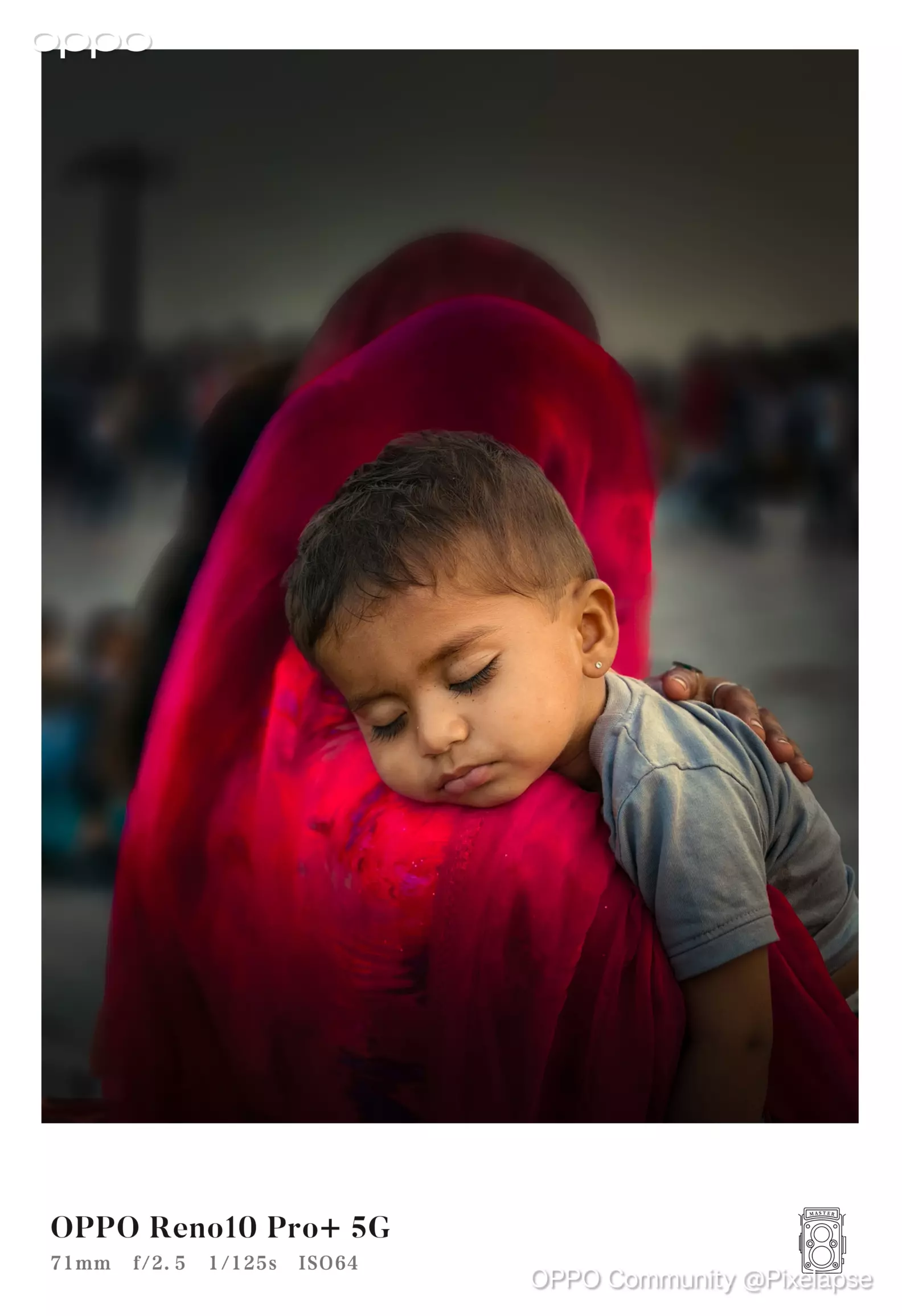 Wrapped in a saree, she cradles her sleeping son close to he