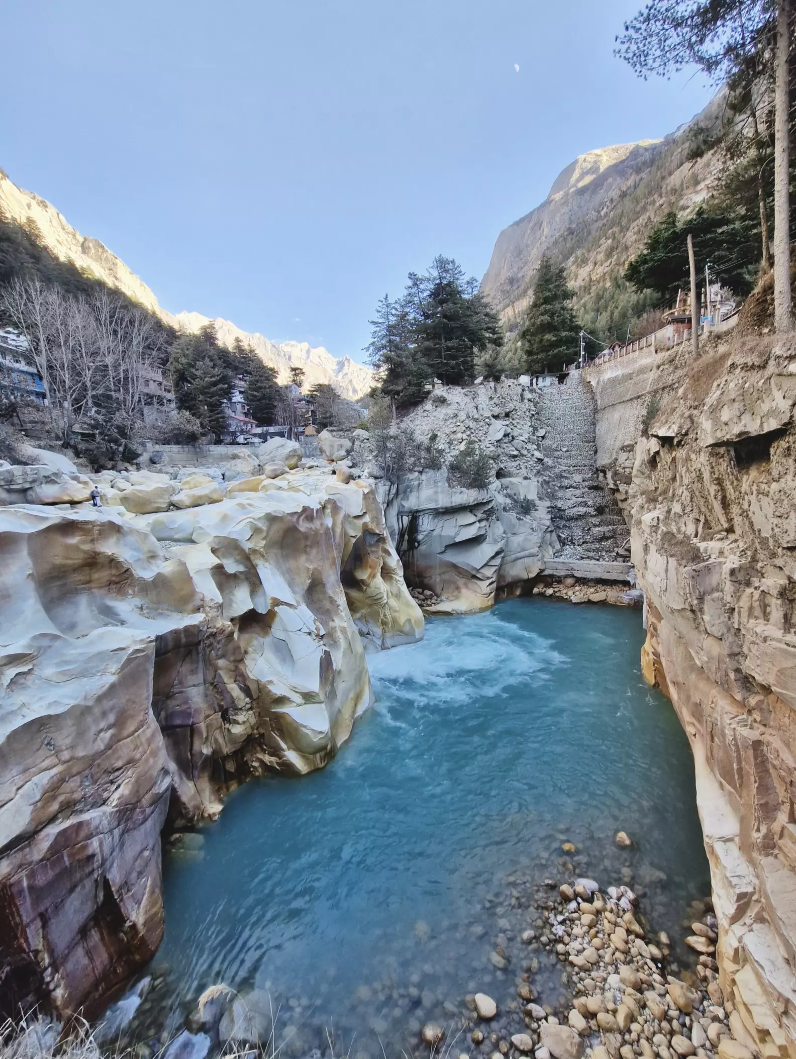 Standing by this crystal-blue river, watching the water carv